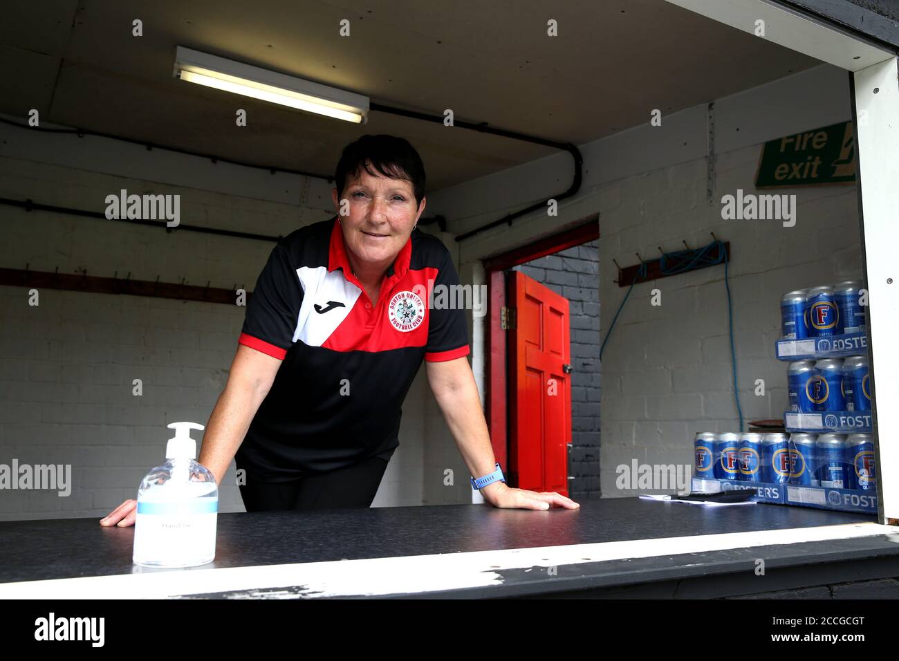 Ashton United staff member Carol Finnigan serves refreshments before ...