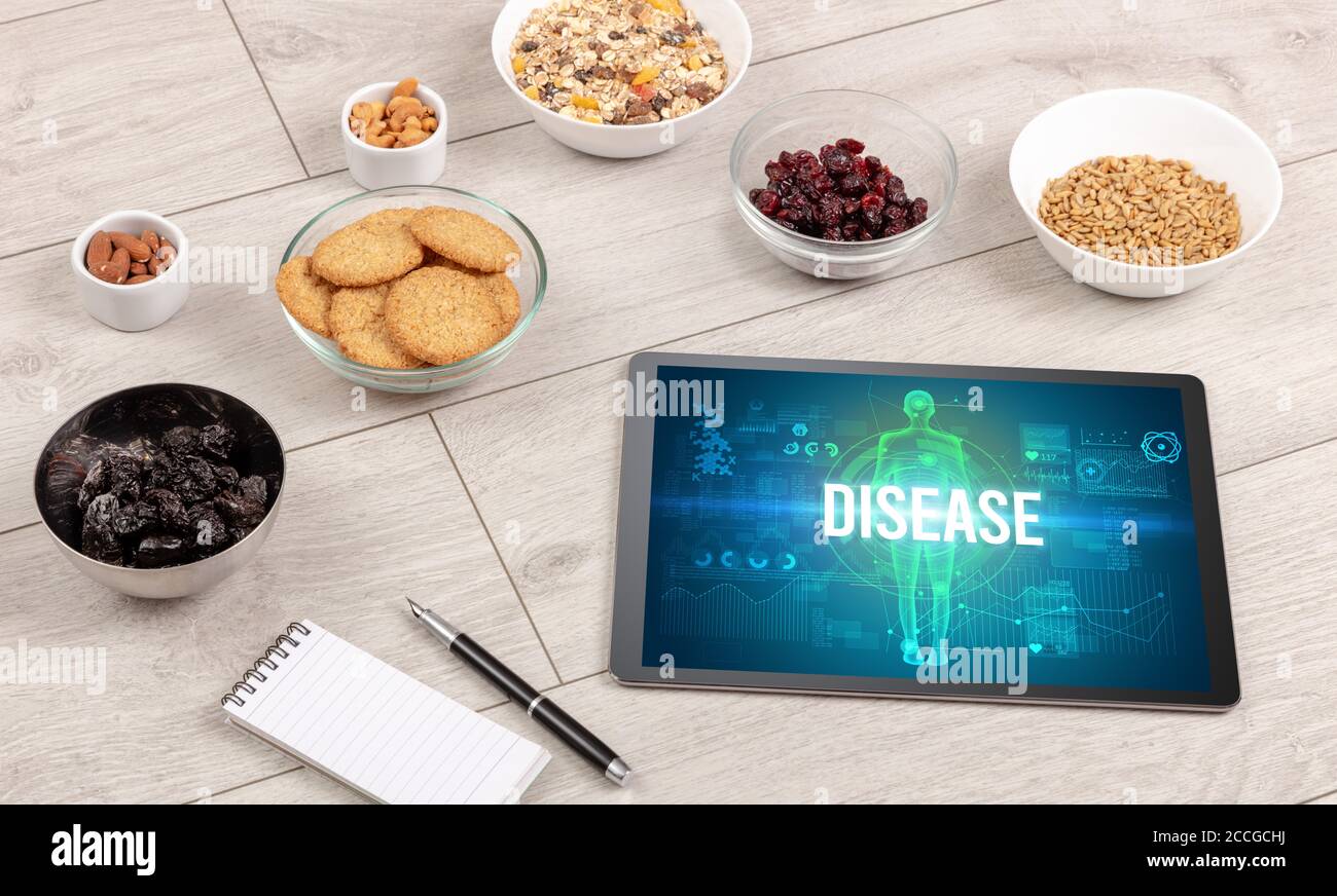 DISEASE concept in tablet with fruits, top view Stock Photo - Alamy