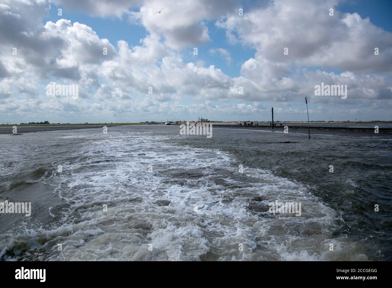 Closeup shot of water splash behind the ship with beautiful blue sky ...