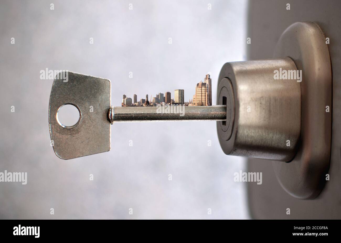 Key with city skyline inside a door lock Stock Photo - Alamy