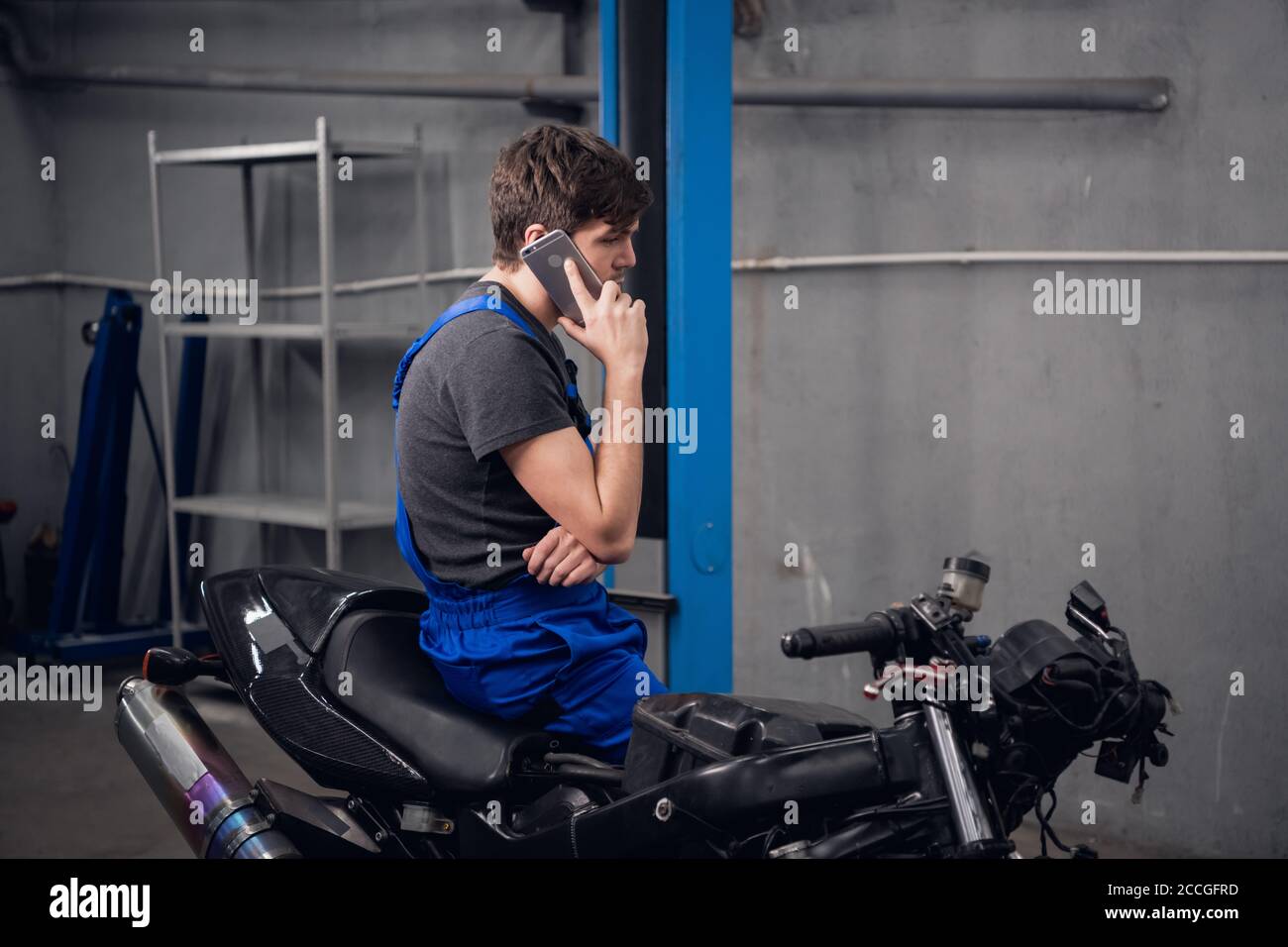 Man on motorcycle talking on mobile hi-res stock photography and images ...