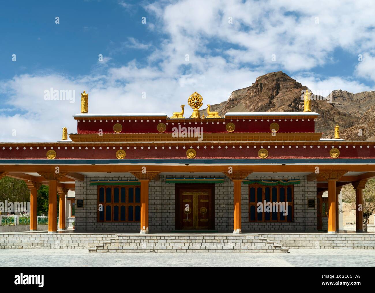 Modern Buddhist gompa against Himalayas and bright sky in summer on ...