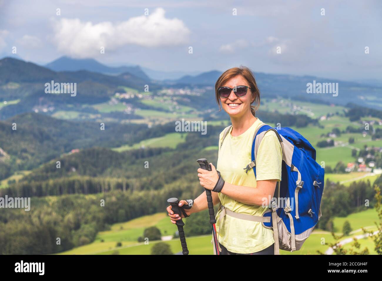 Young slim backpacker tourist girl is enjoying the view on rocky ...