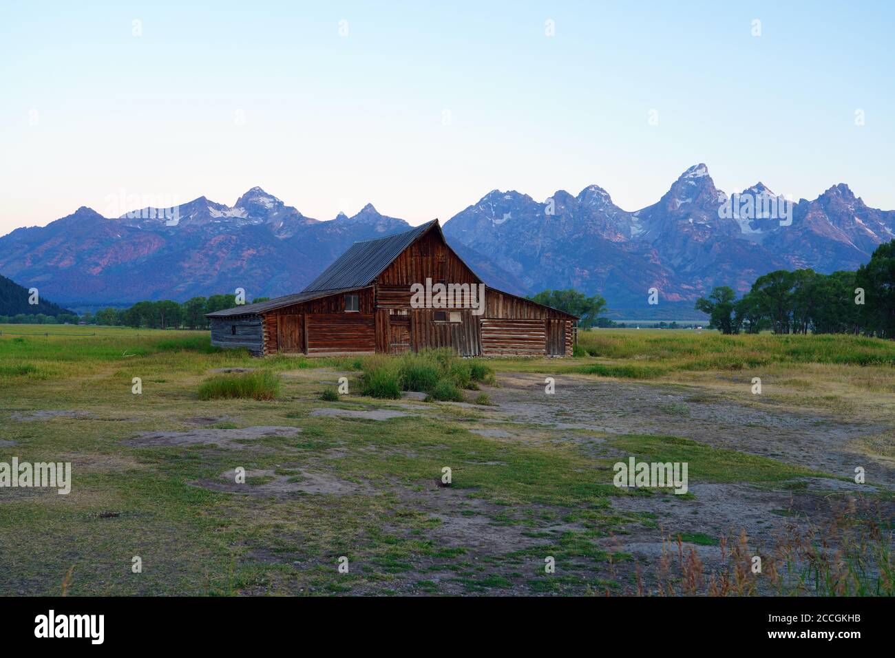 Sunrise over a log cabin on Mormon Row Historic District in Antelope ...