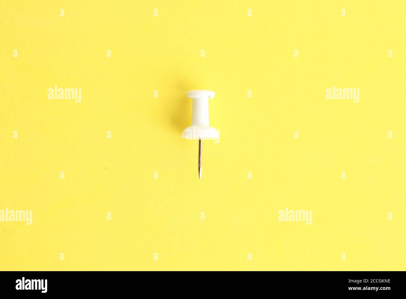 Top view of a plastic thumbtack on a yellow background Stock Photo - Alamy