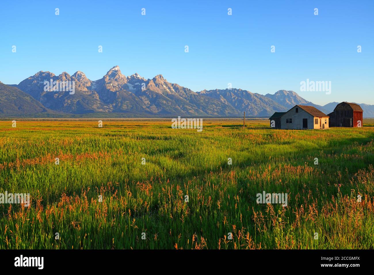 Sunrise over a log cabin on Mormon Row Historic District in Antelope ...