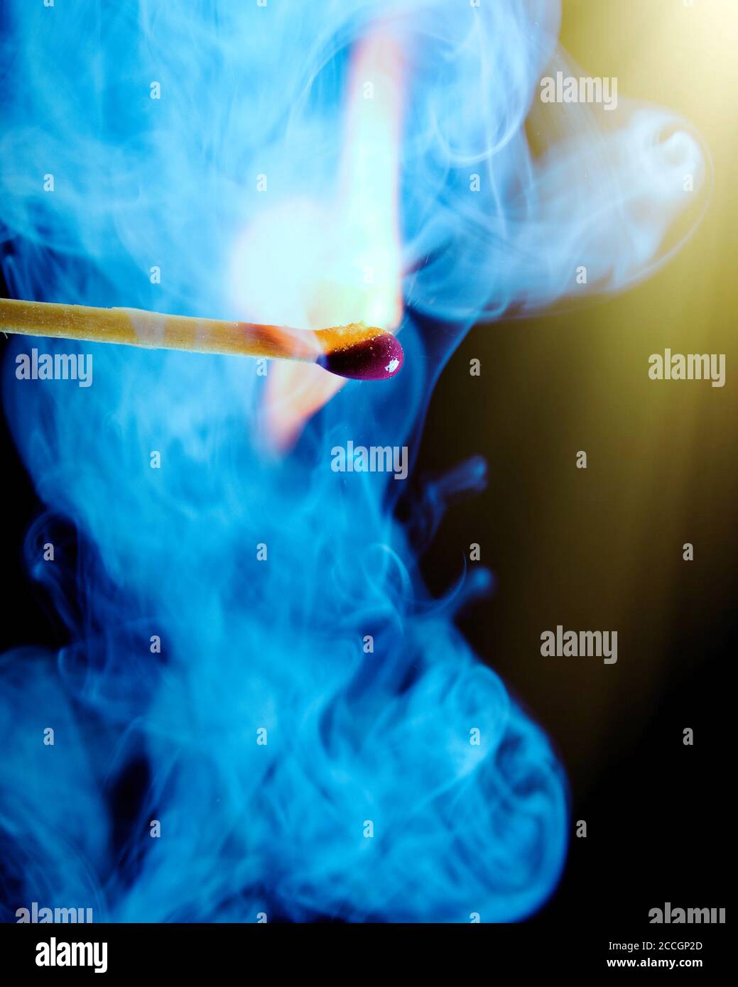 Burning match with blue smoke over black background Stock Photo - Alamy