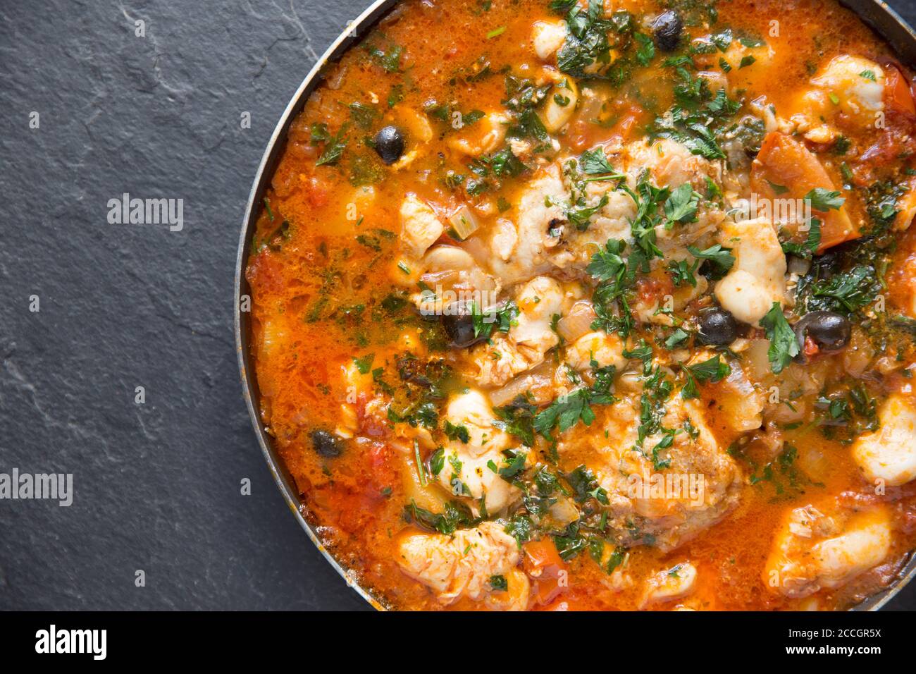 A panful of homemade fish stew featuring monkfish cheeks and ray cheeks ...