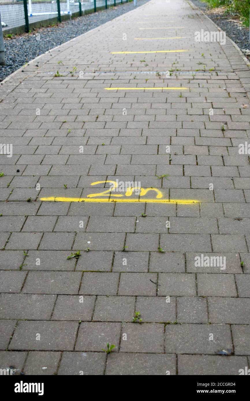 2 metre yellow mark sign with arrow on brick bath leading to school ...