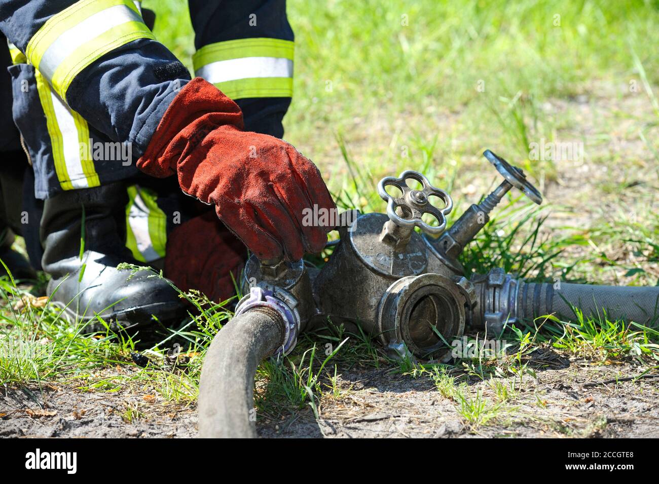 Fireman hand in glove turning valve of water pump system Stock Photo ...