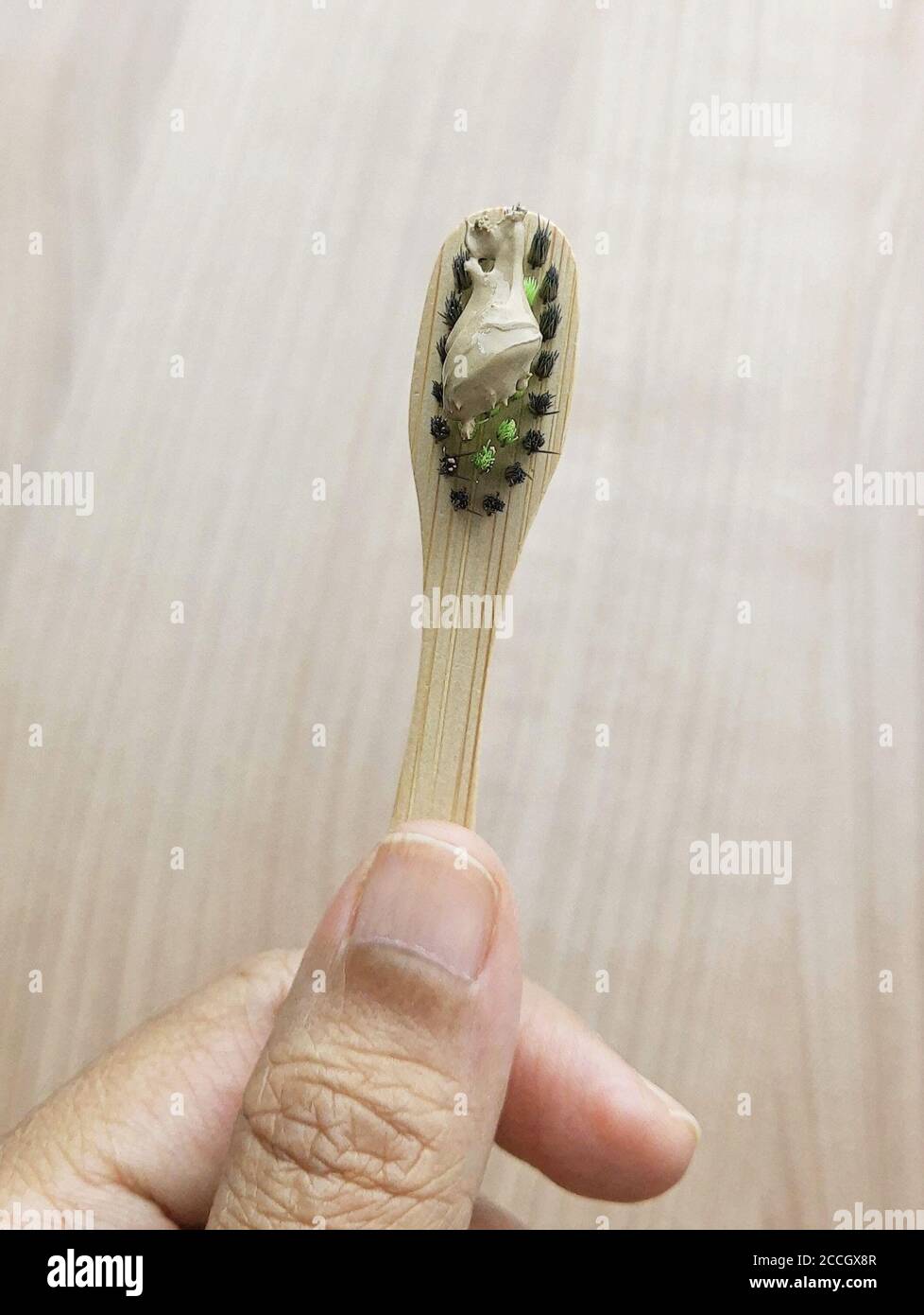 Hand Holding Wooden Bamboo Toothbrushes with Herbal Toothpaste. An Oral ...