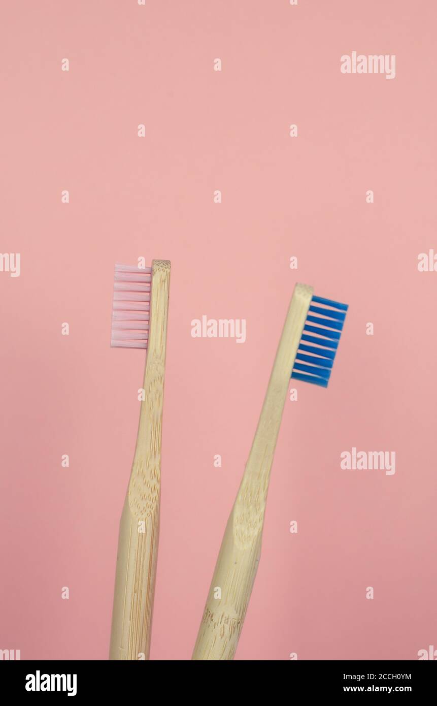 Close up shot of wooden pink and blue toothbrush representing a couple ...