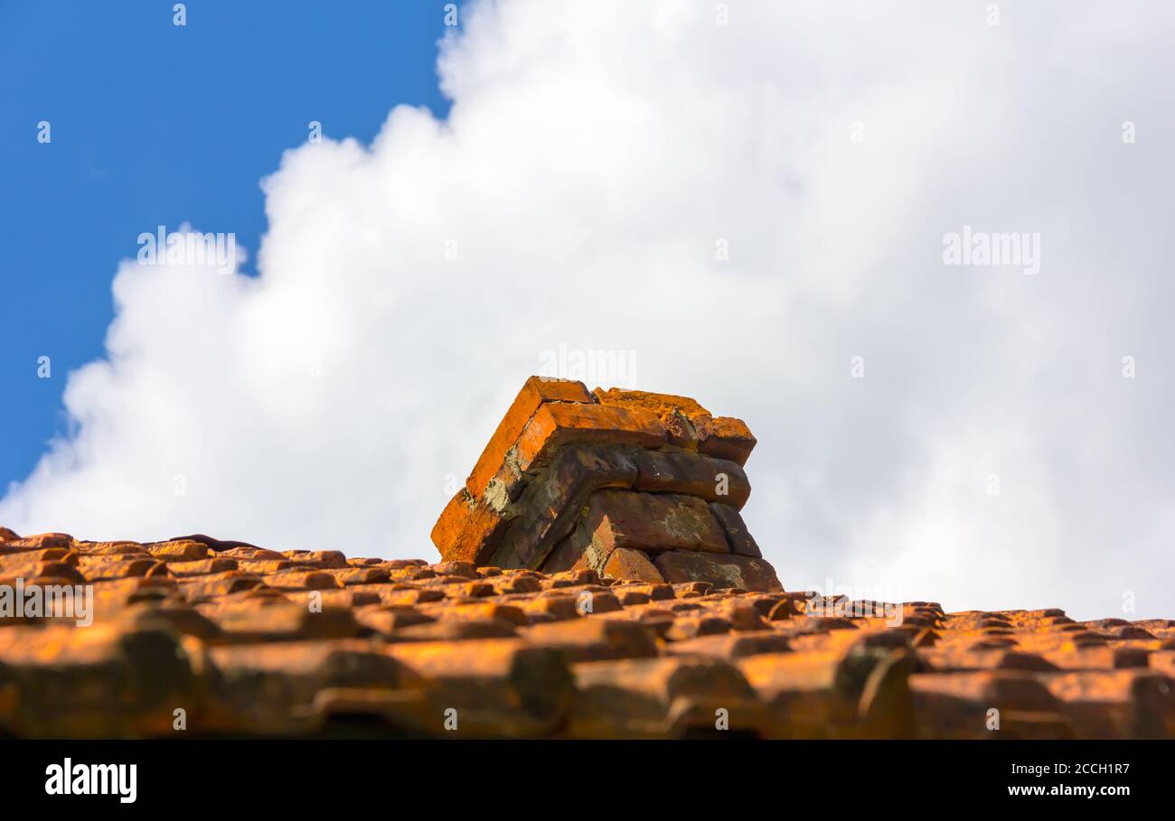 a fragment of clay tile roof with brick chimney Stock Photo - Alamy