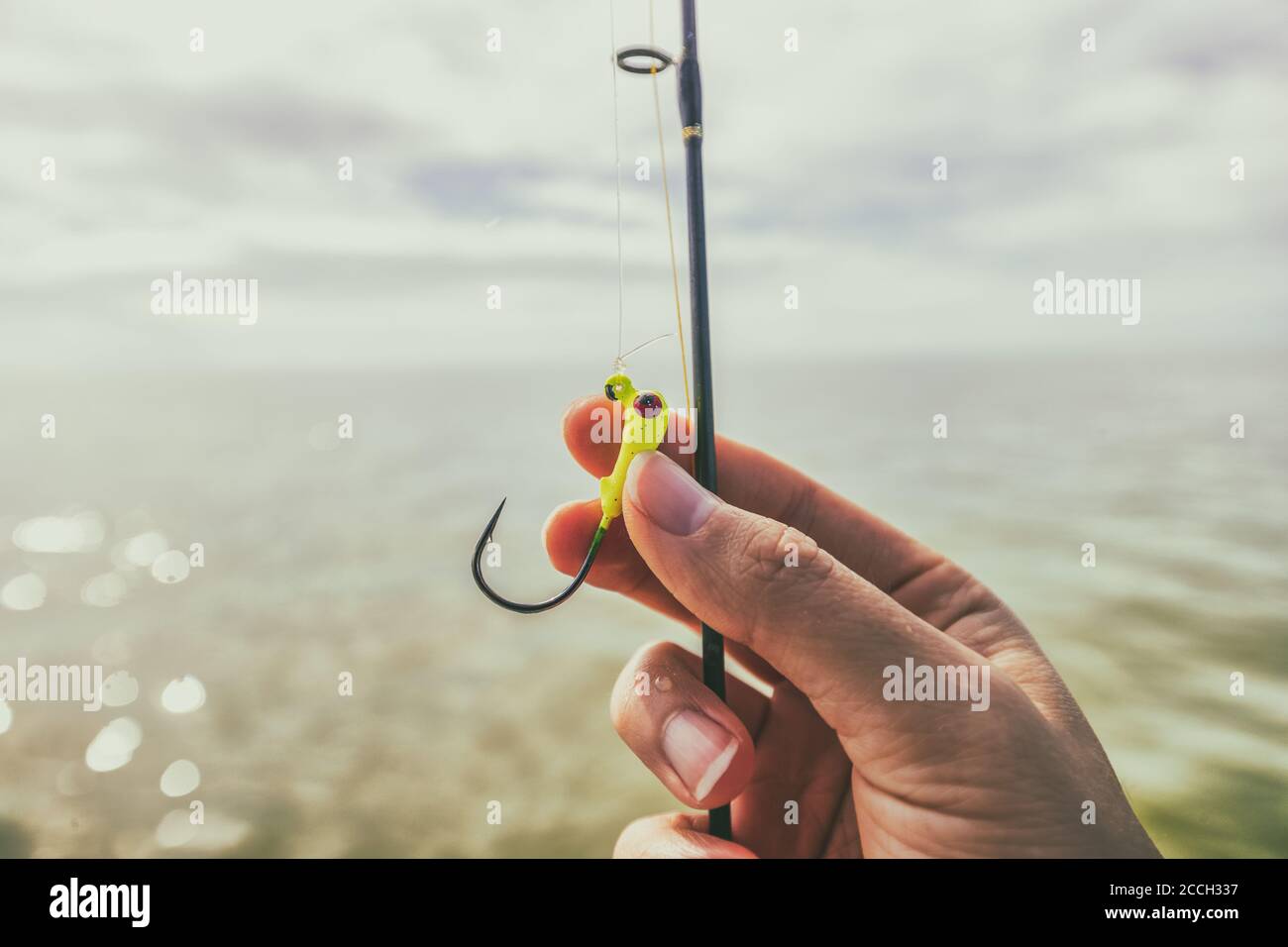 Fishing hook closeup watersport gear. Woman hand holding line Stock ...