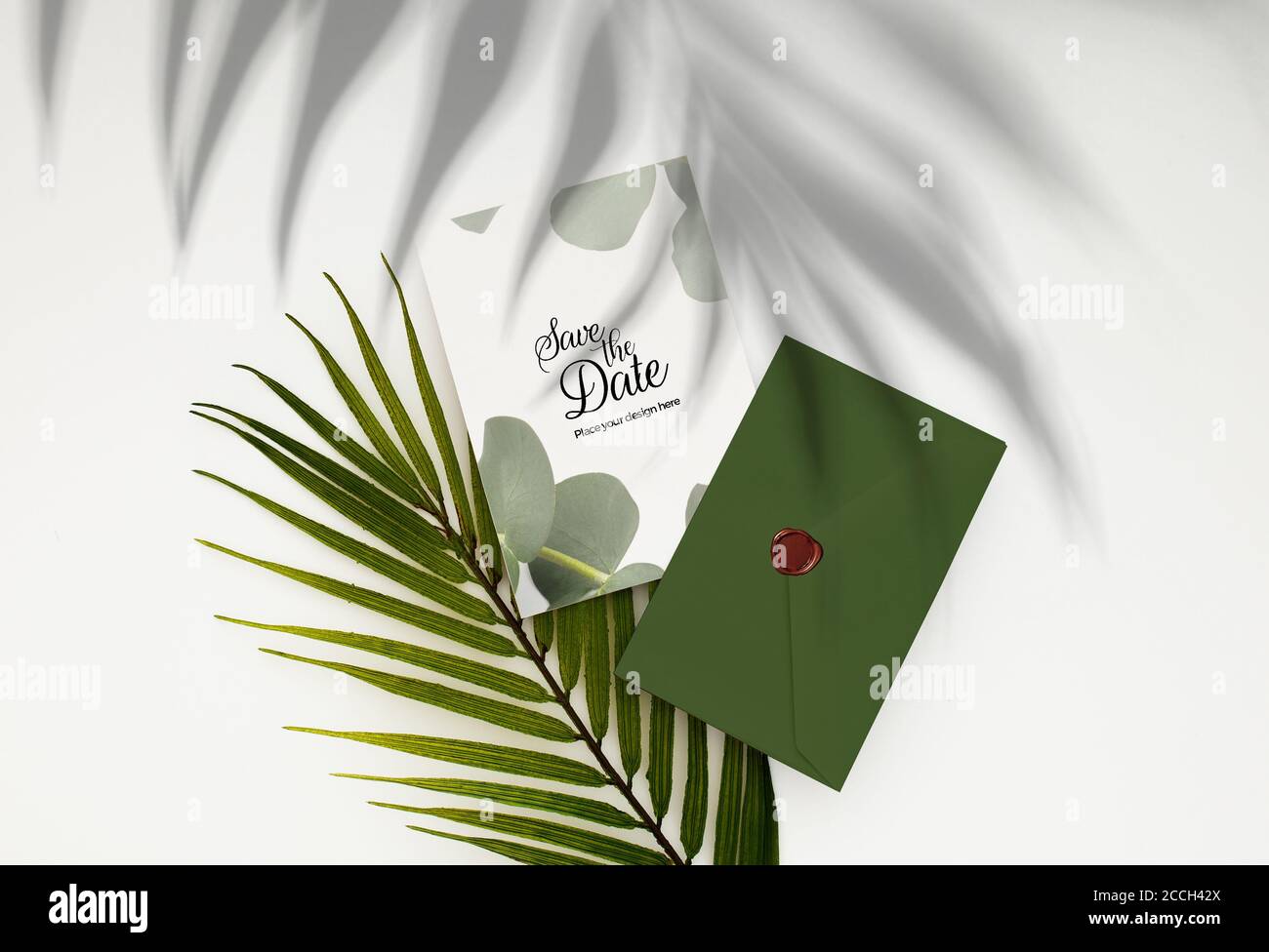 Top view of wedding invitation letter papers decorated with leaves ...