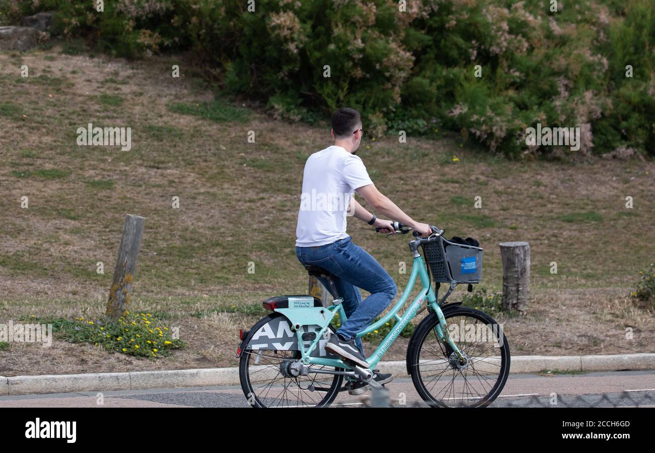 A man riding a bike in Brighton, East Sussex, UK Stock Photo - Alamy