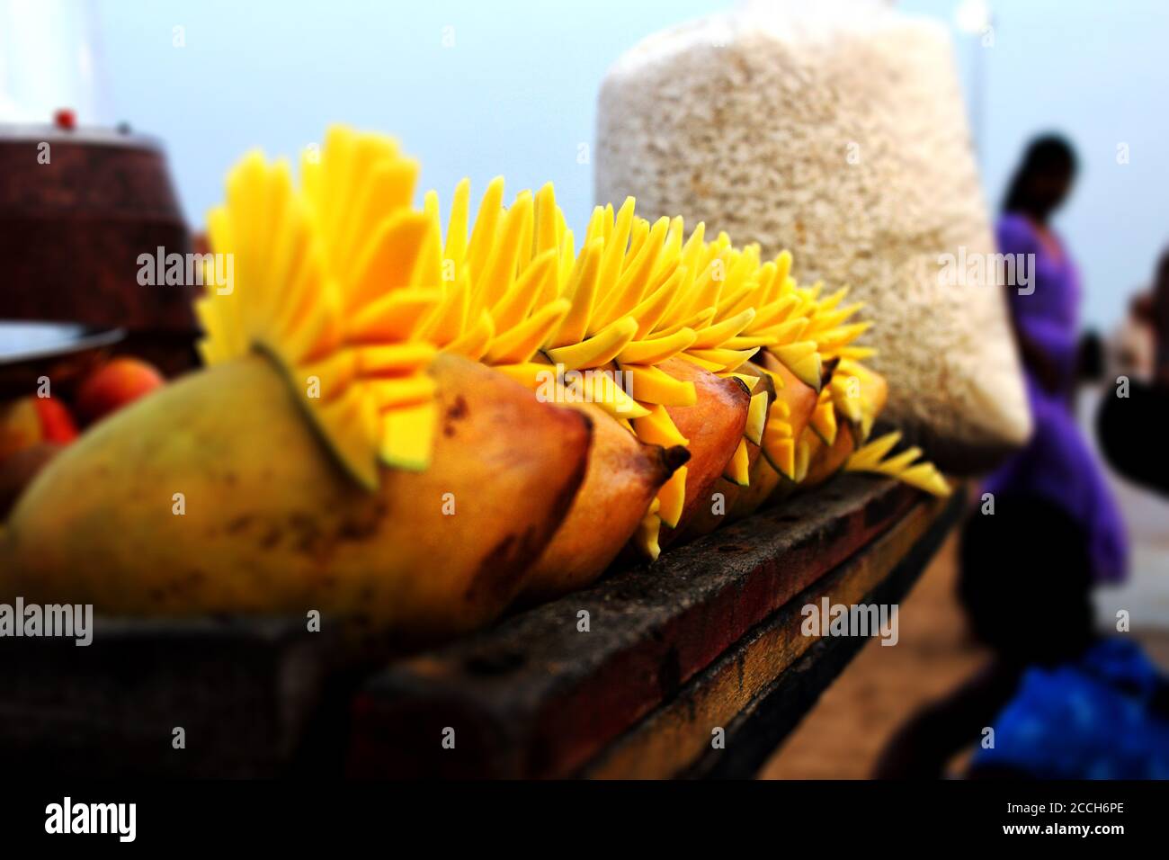 Perspective shot. Diced Raw mangoes on a vendor’s cart at the beach ...