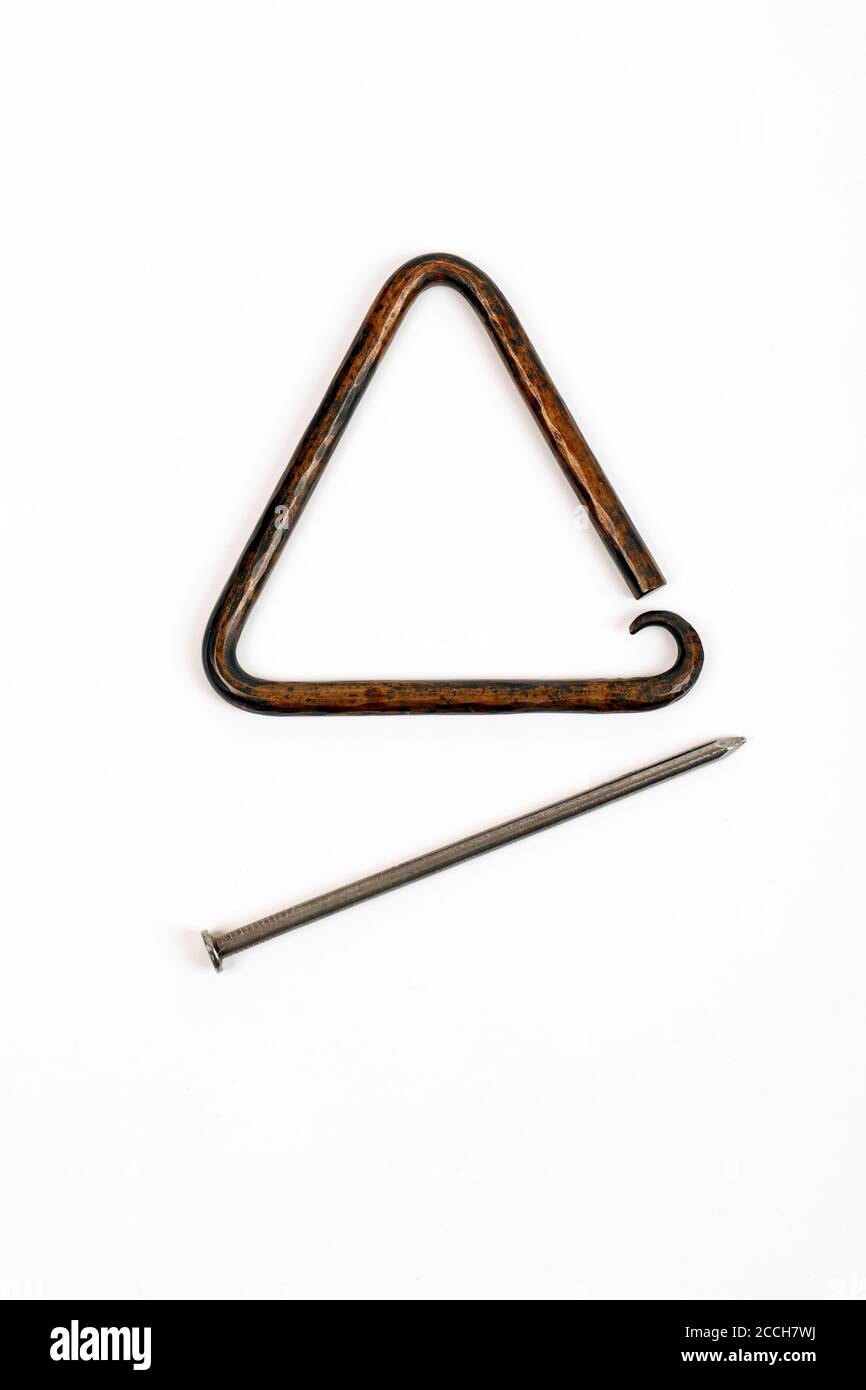 Ornate hand-beaten bronze Triangle with decorative curled or curved ...