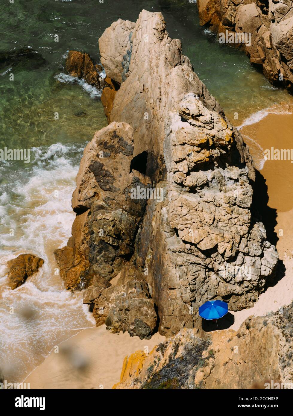 Vertical high angle shot of big rock formations on the coast of the sea ...