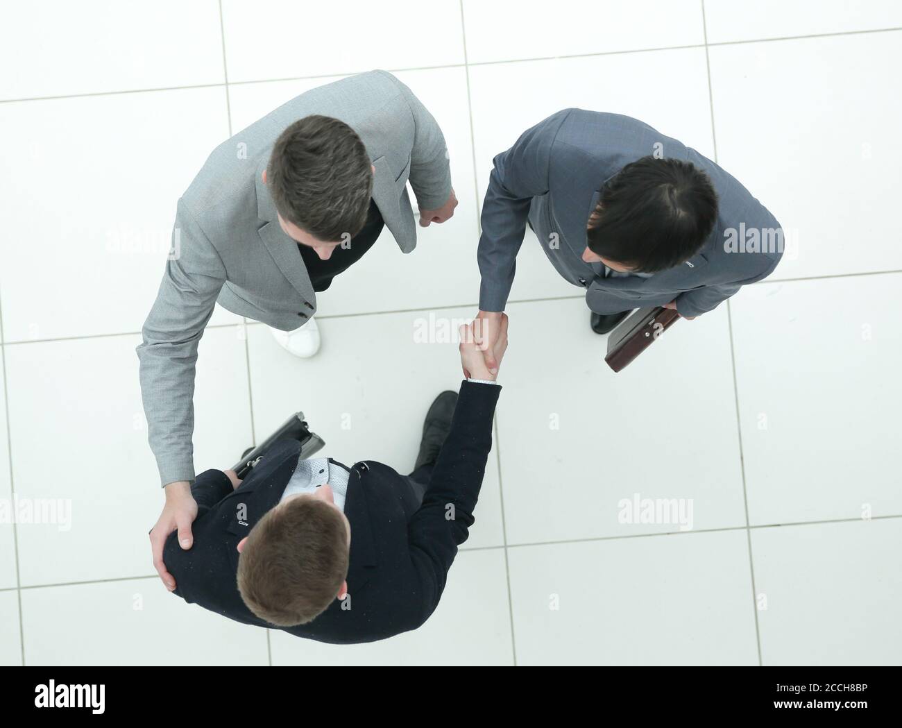 top view. business people confirm the transaction with a handshake ...