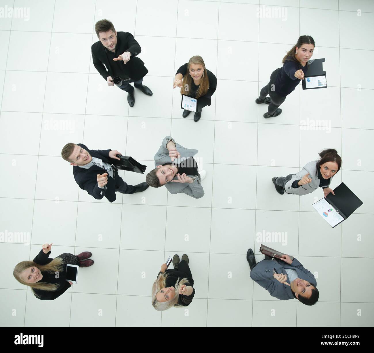 top view. group of serious diverse business people looking at the ...