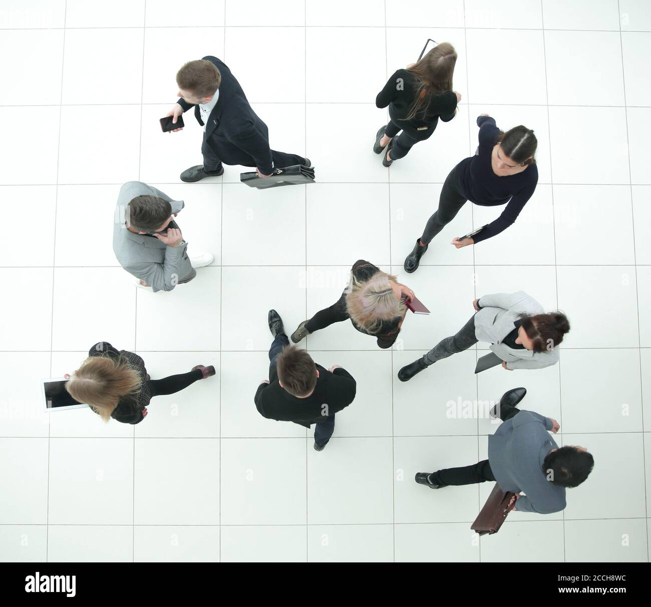 top view. group of serious diverse business people looking at the ...