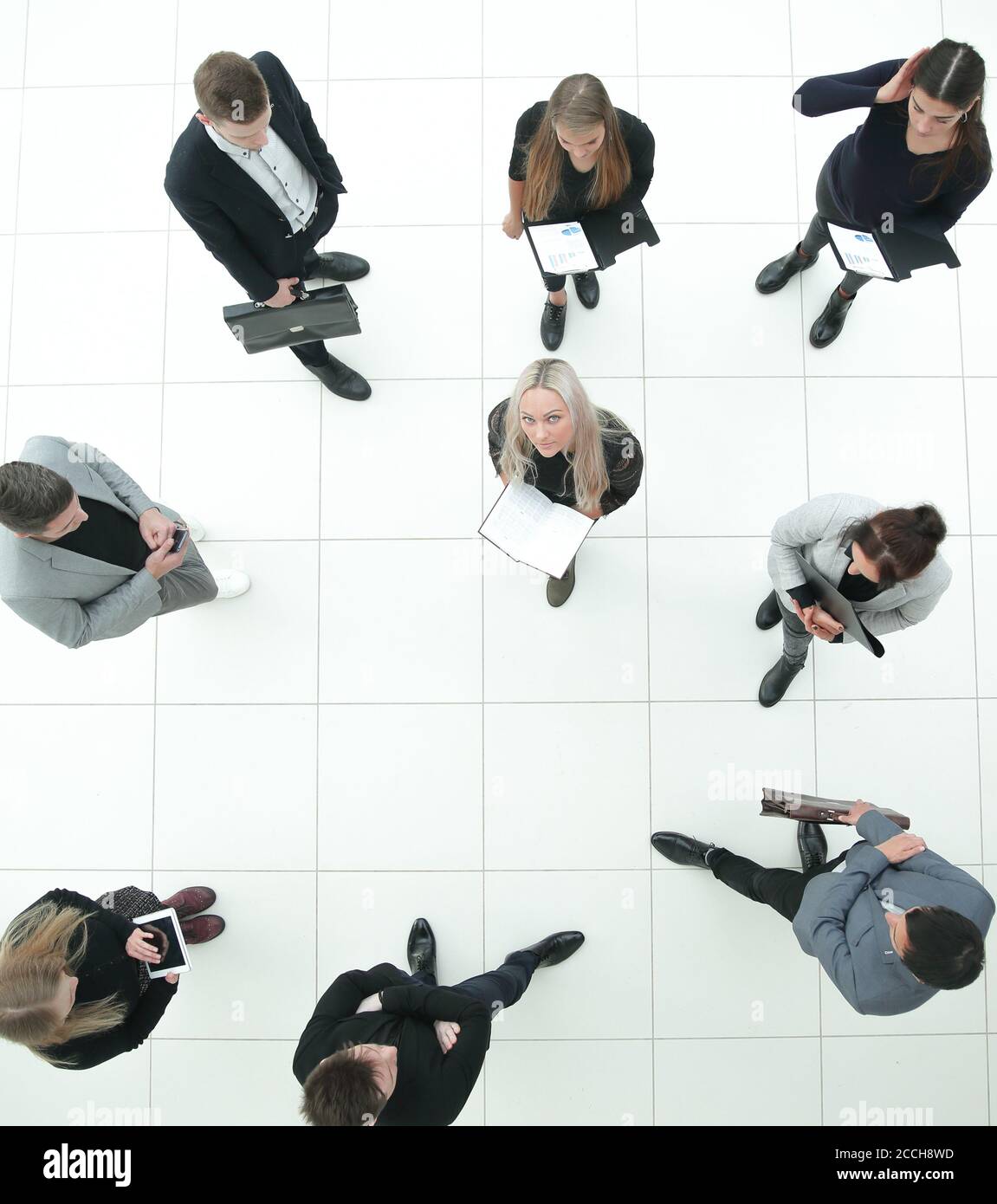 top view. group of serious diverse business people looking at the ...