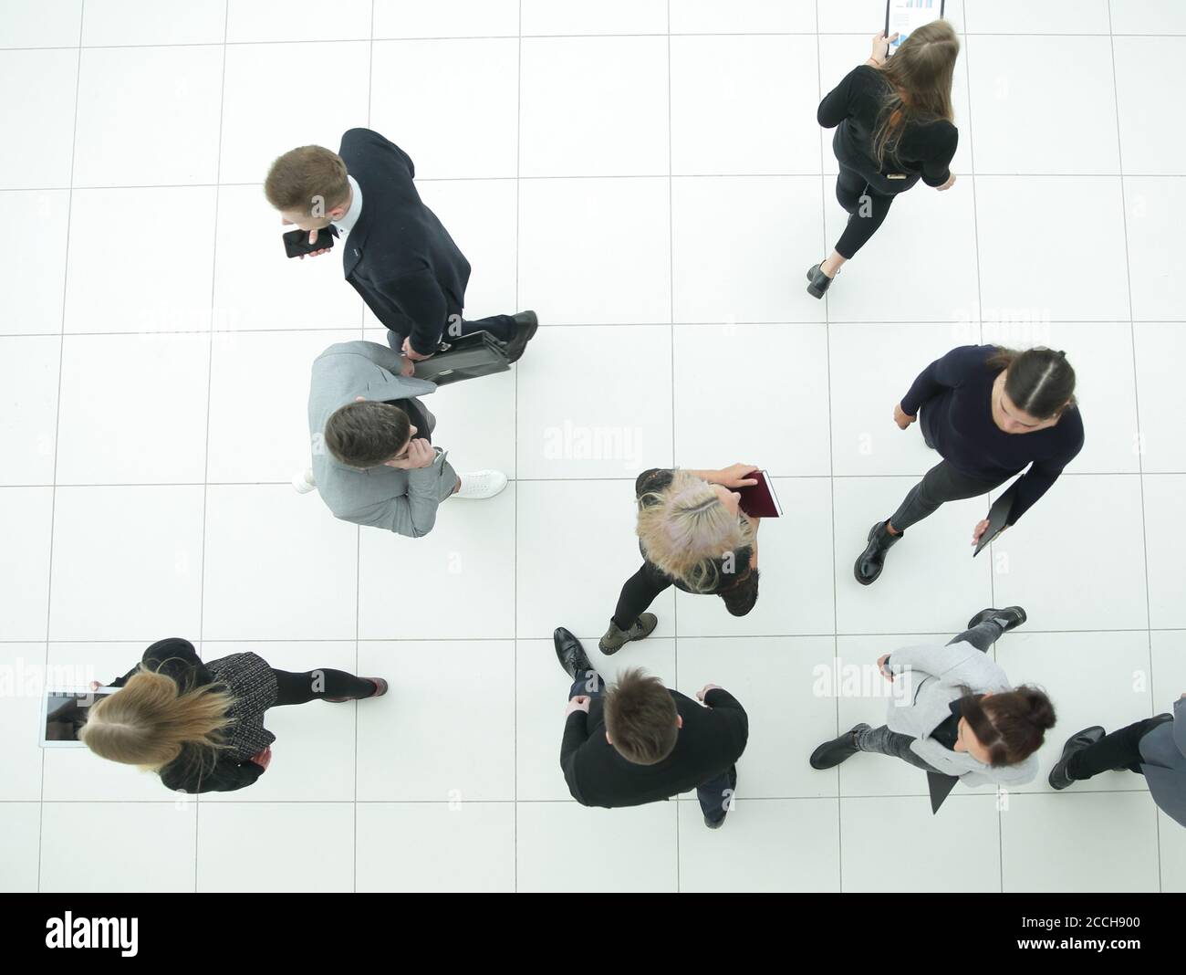 top view. group of serious diverse business people looking at the ...