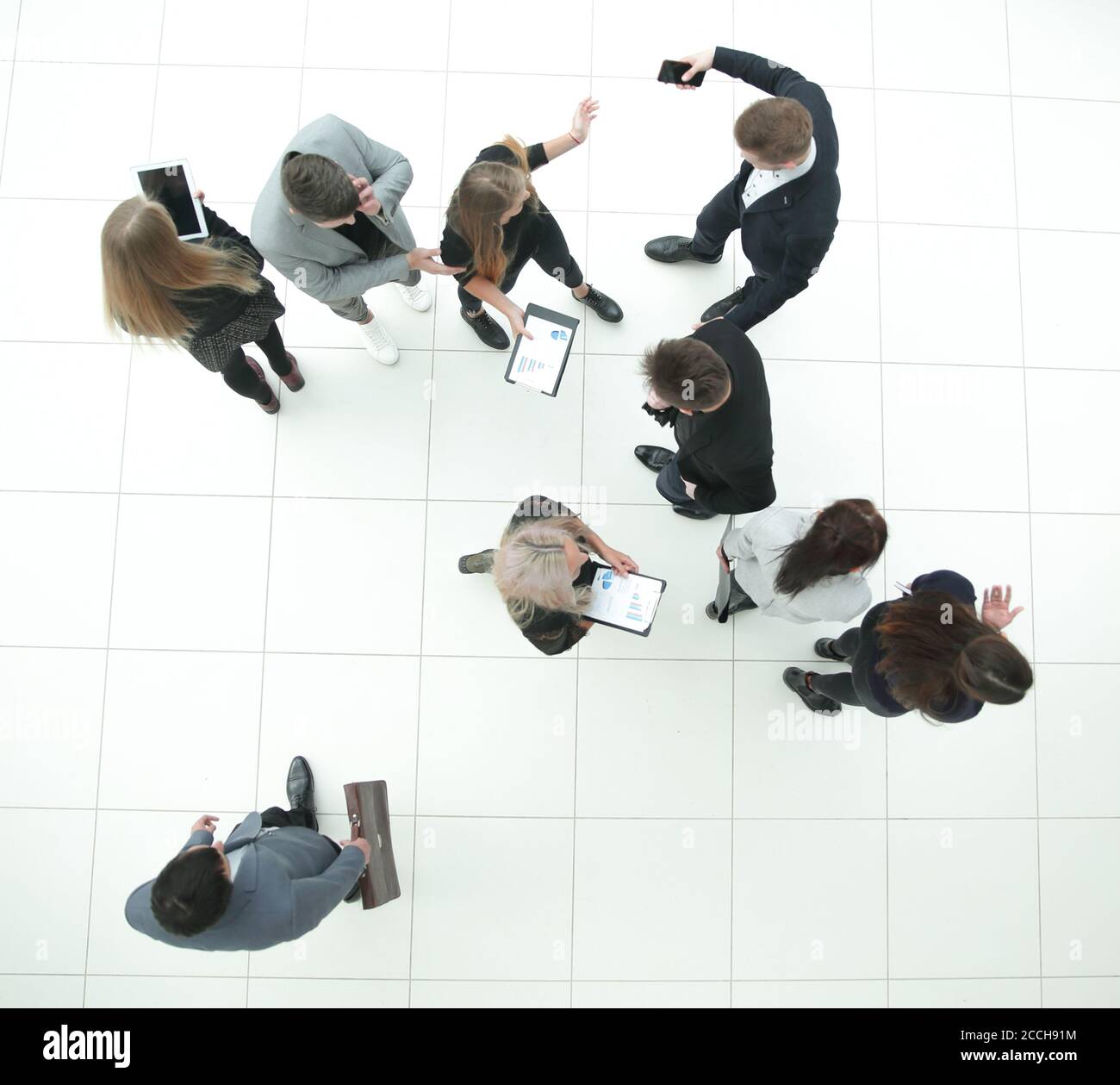 top view. group of serious diverse business people looking at the ...