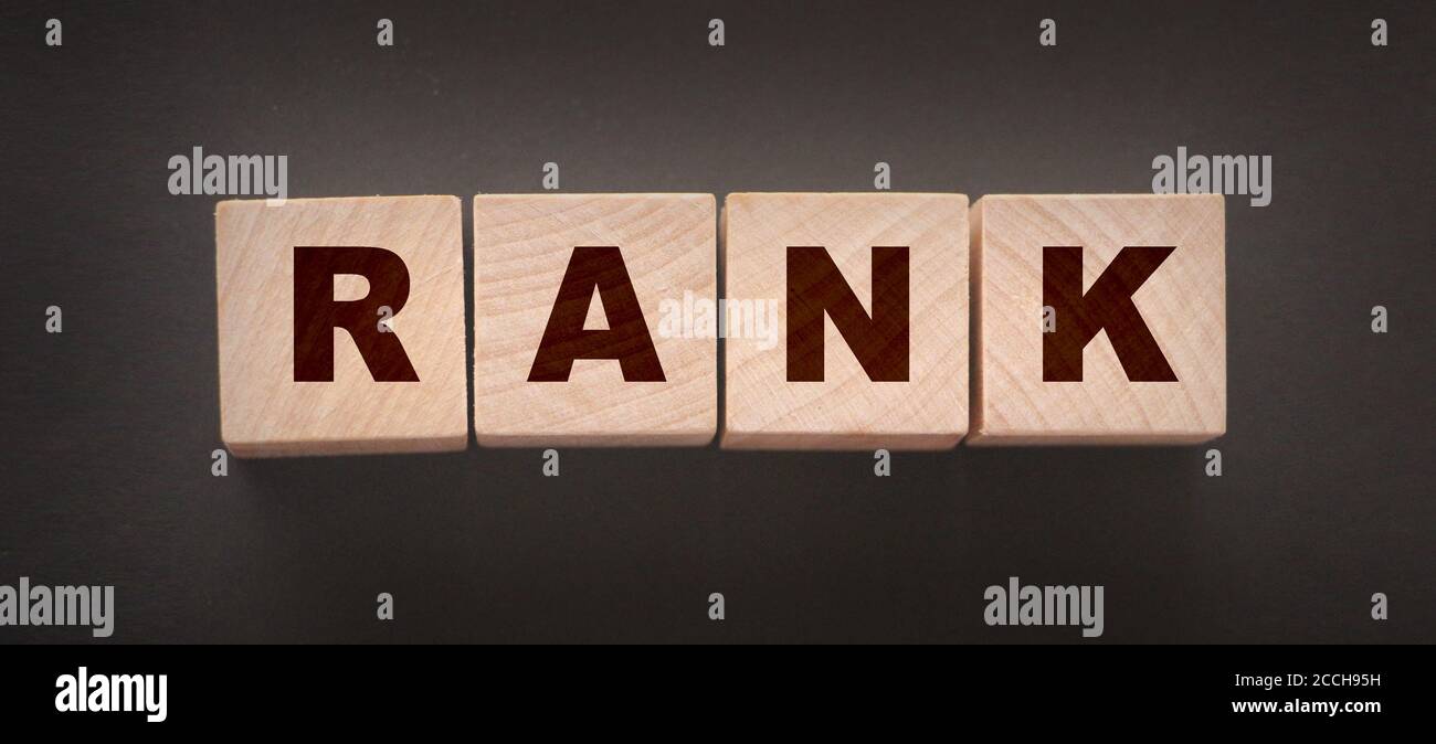 RANK text on a black background on wooden cubes. Ranking SEO concept ...