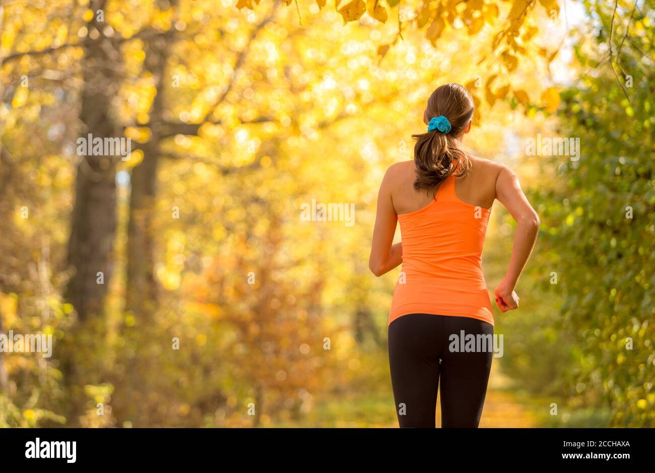Young brunette woman running in autumn forest. Lifestyle and sport ...