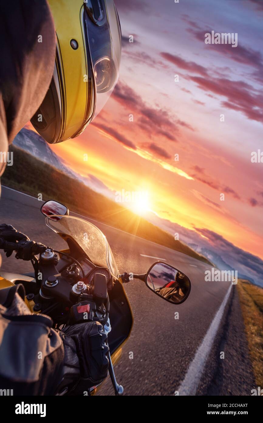 Close-up of motorcycle driver riding in Alpine highway. Outdoor ...