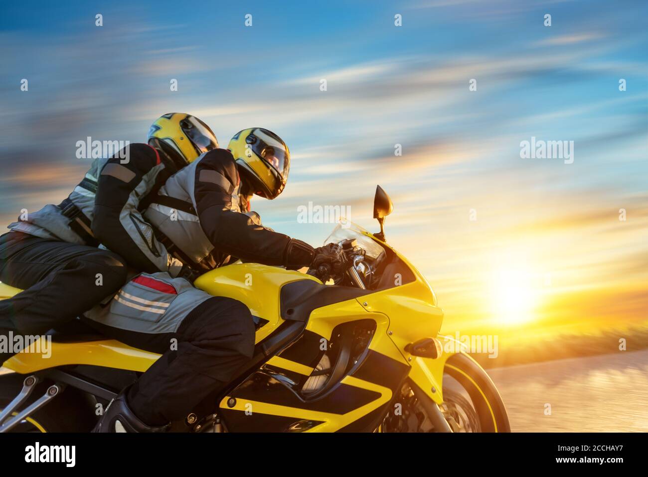 Motorbikers on sports motorbike riding in sunset. Outdoor photography ...