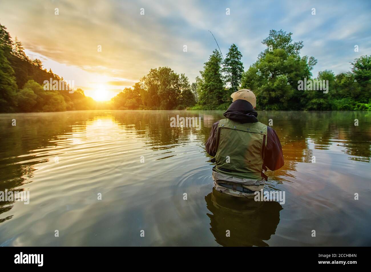 Sport fisherman hunting predator fish. Outdoor fishing in river during ...