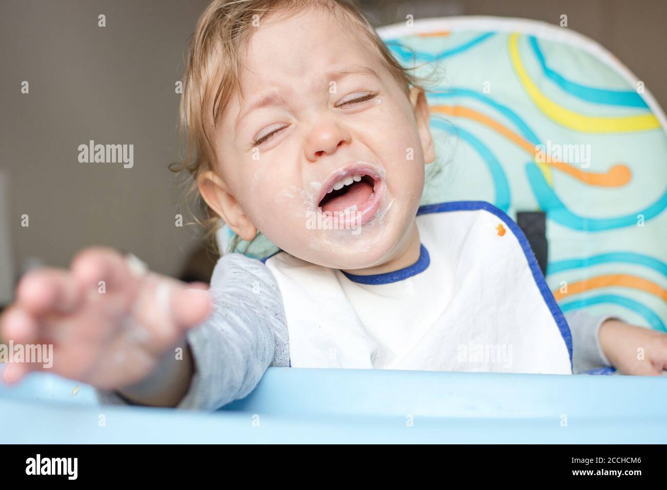 Cute baby child not liking the food and crying over feeding time Stock ...