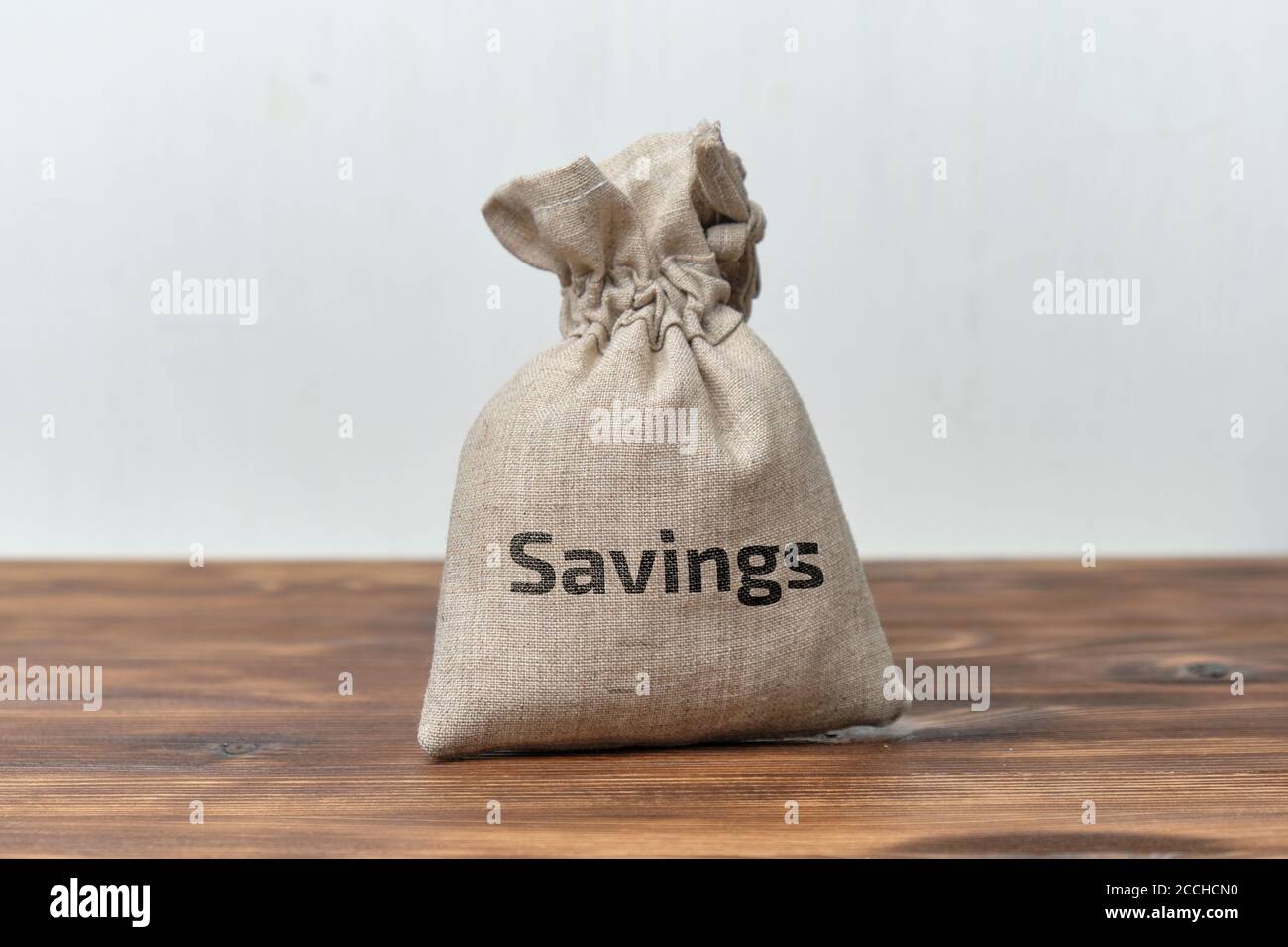 Money savings concept in a cloth bag Stock Photo - Alamy