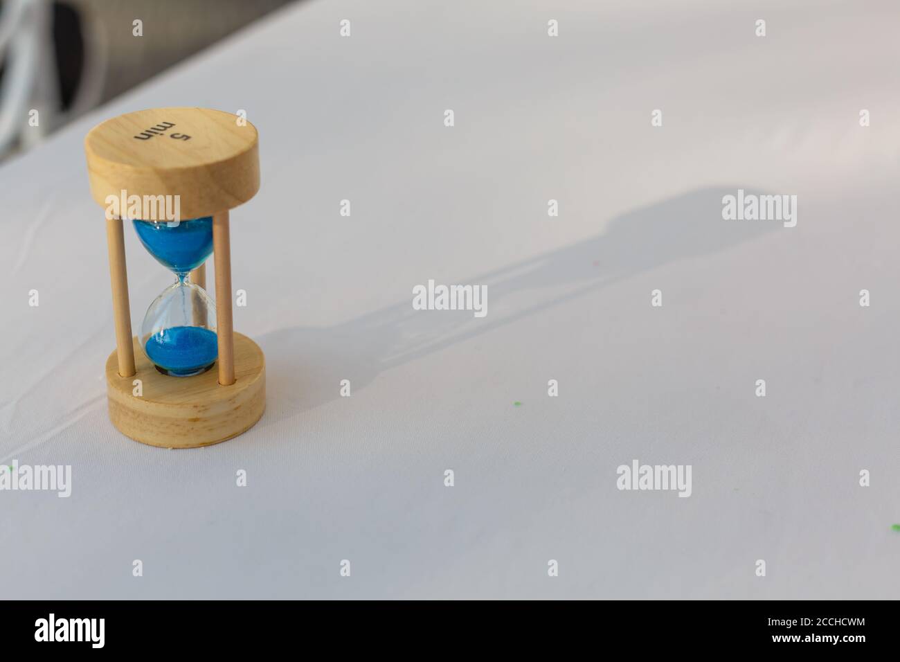 Sand running through the bulbs of an hourglass measuring the passing ...