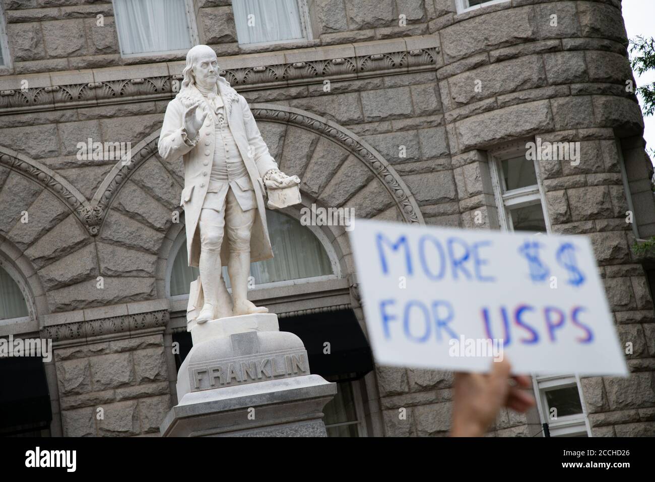 A statue of Benjamin Franklin is seen during a protest against changes ...
