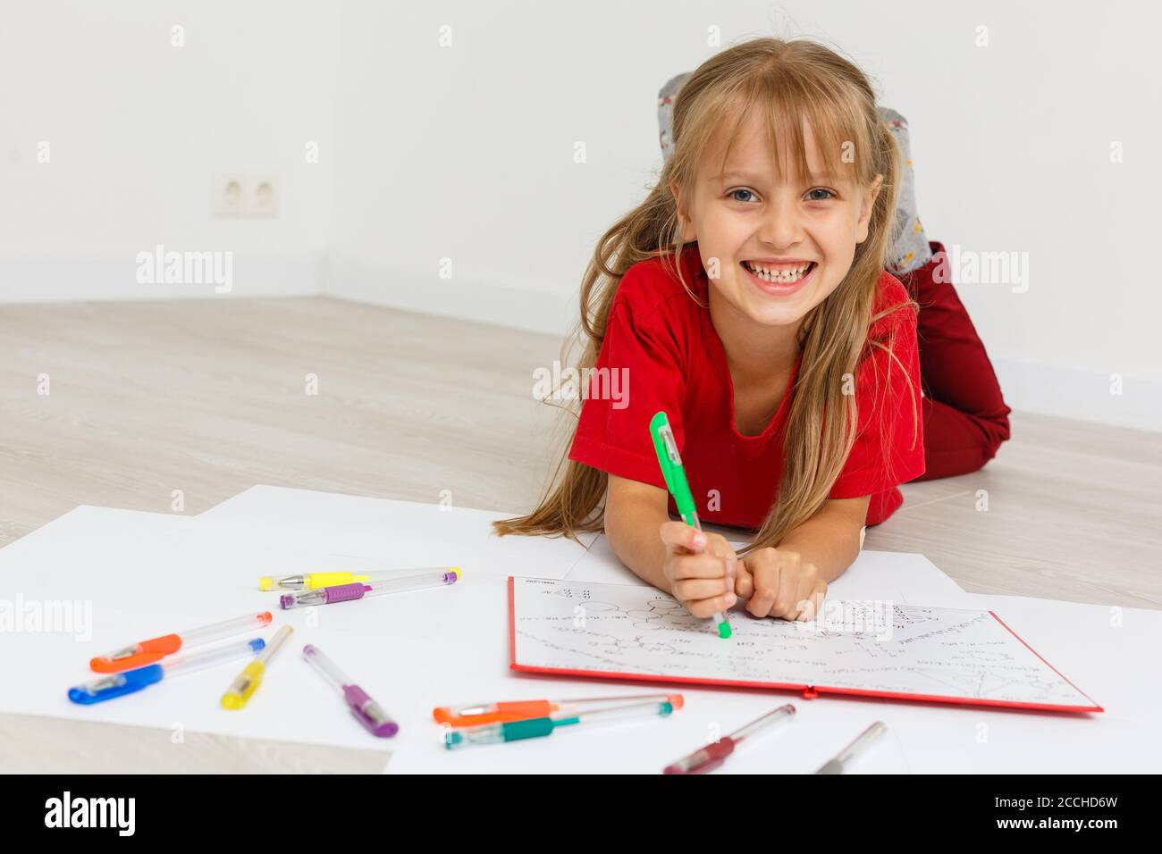 Education at home concept - Cute little girl studying with pile of ...