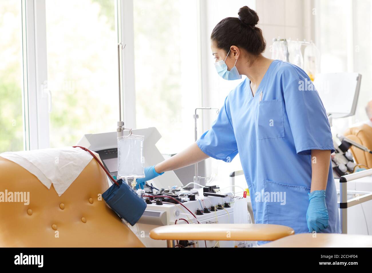 Nurse in uniform checking and preparing medical equipment for blood ...