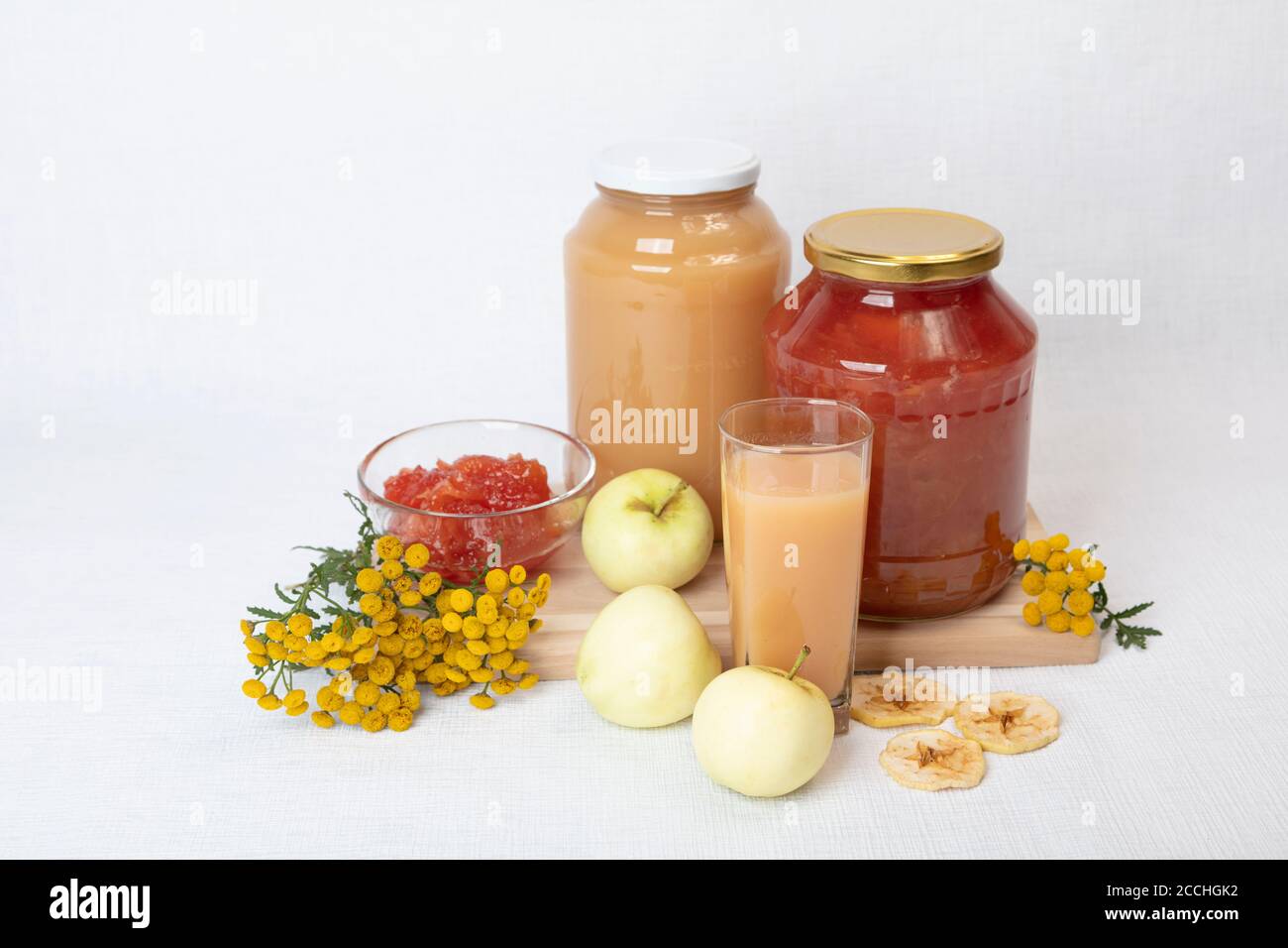 Apple jam and juice, fresh and dried apples, flowers, still life ...