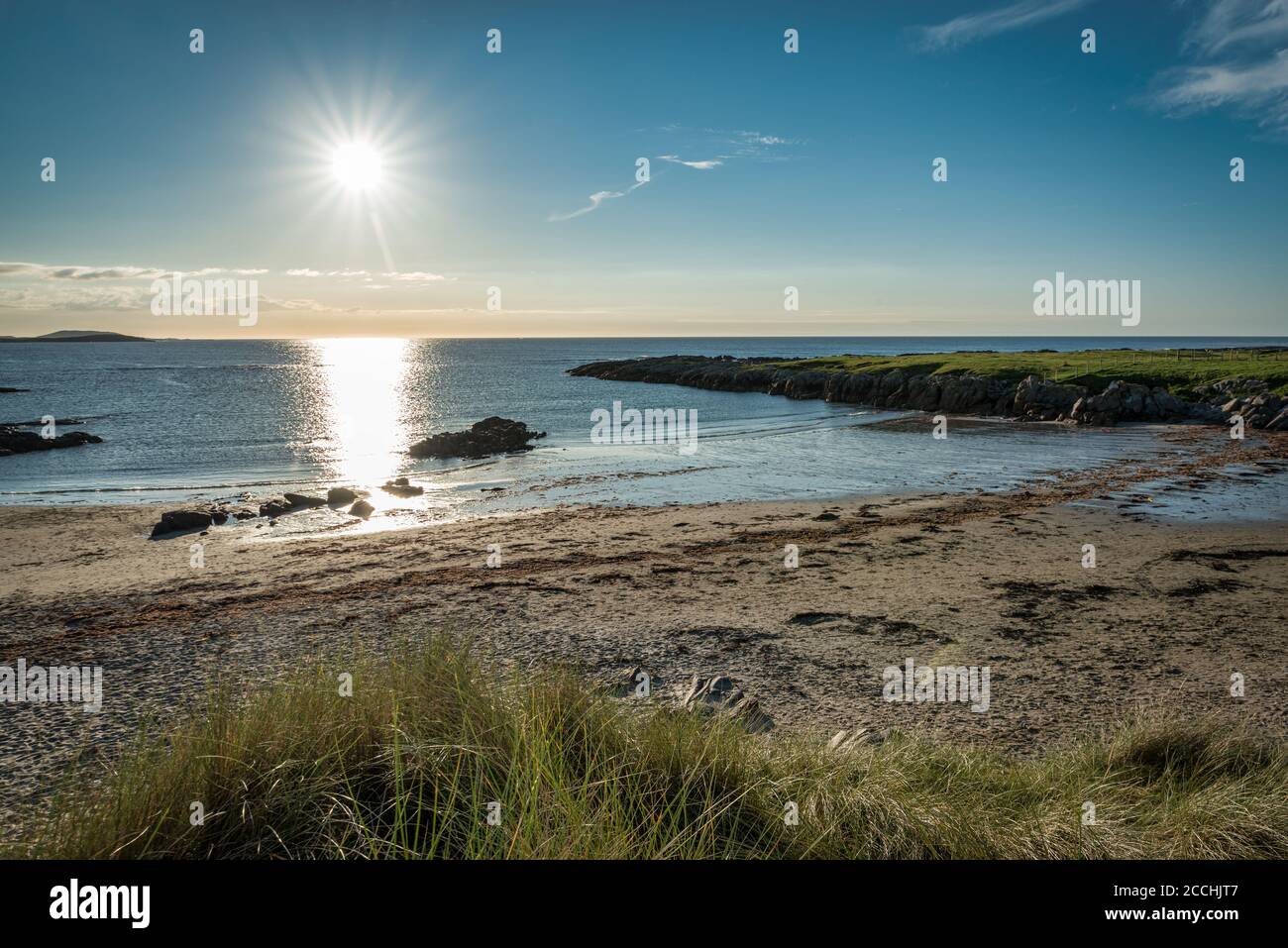 Sand dunes covered in grass on Ballyheirnan Beach in Donegal Ireland ...