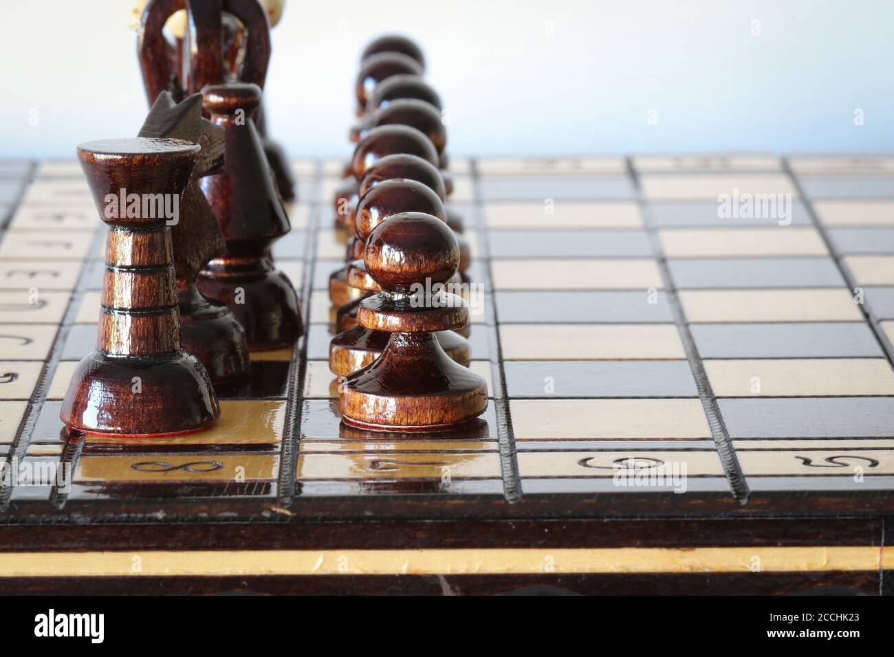 White chess pieces arranged on chess board before start of gameplay as ...