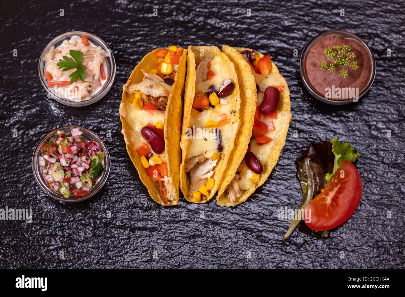three mexican tacos on slate Stock Photo - Alamy