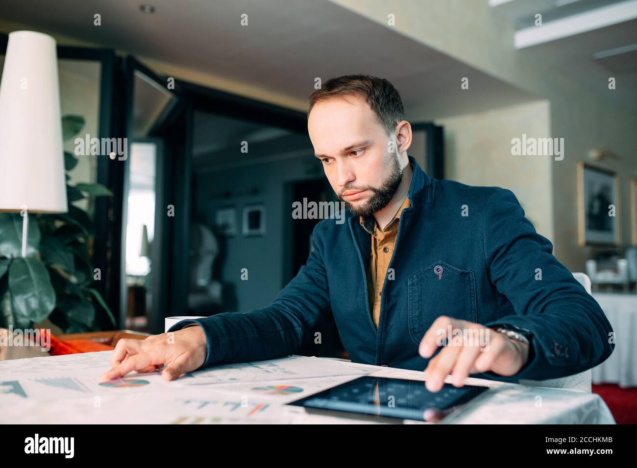 Man Working in Office and Analyzing Some Statistical Calculation ...