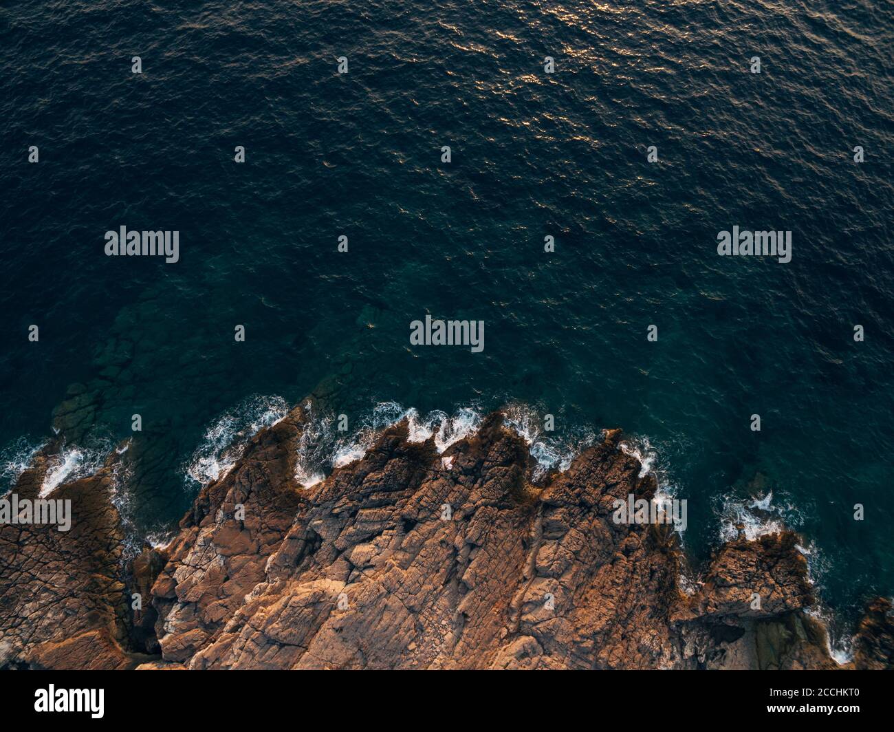 Rocky sea coast, waves hitting the rocks, aerial top view Stock Photo ...