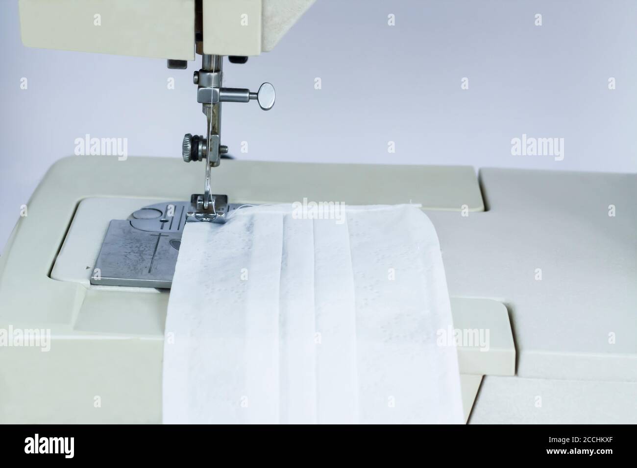 Surgical face mask is sewn on the sewing machine,close up Stock Photo ...