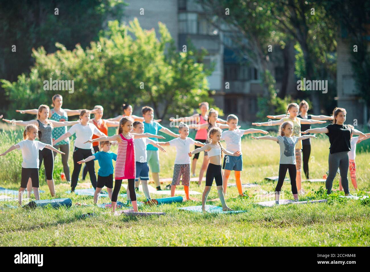 Yoga classes outside on the open air. Kids Yoga Stock Photo - Alamy