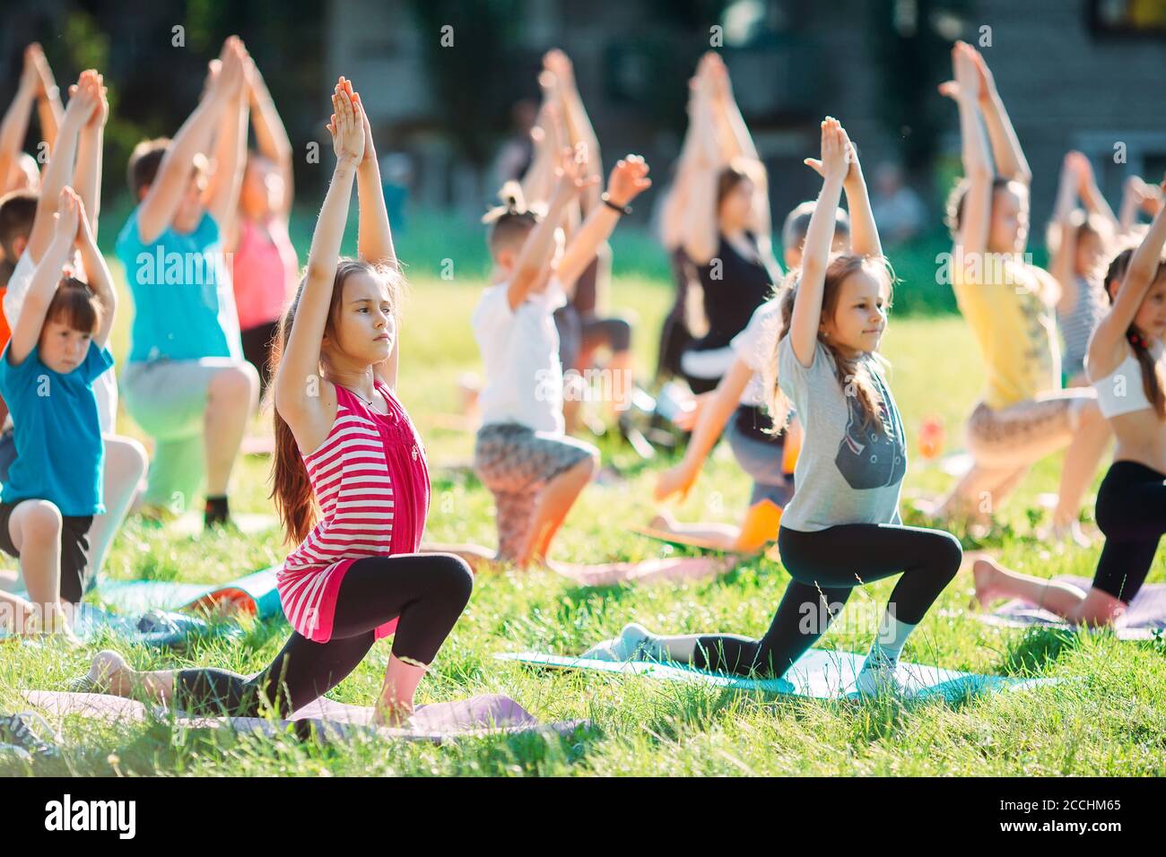Yoga classes outside on the open air. Kids Yoga Stock Photo - Alamy