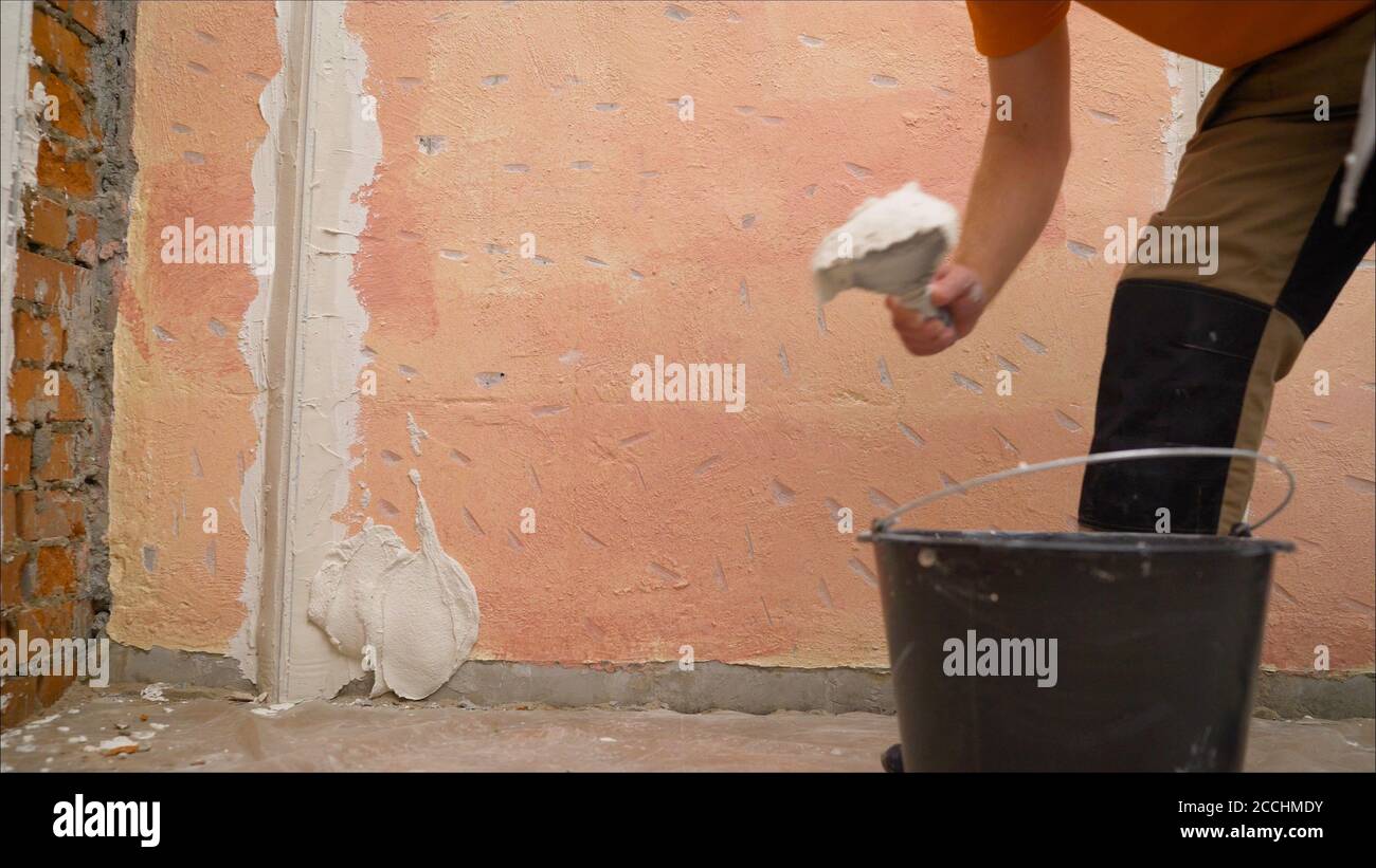 Plasterer putting plaster on wall. Putting plaster on the wall. Stucco ...